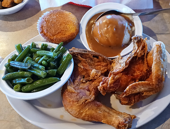 Golden-brown fried chicken with that perfect crackle-crunch exterior and sides that refuse to be upstaged.