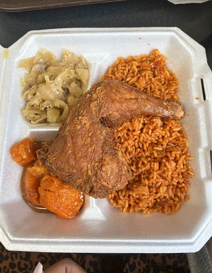 This isn't just fried chicken with sides—it's a Southern trinity of crispy perfection, tomato-infused rice, and tender cabbage that makes you question all other meals.