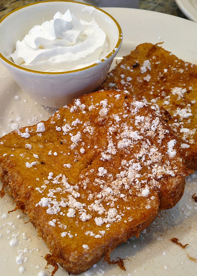 Golden-brown French toast dusted with powdered sugar &ndash; this isn't breakfast, it's edible sunshine that makes you forget you're an adult with responsibilities.