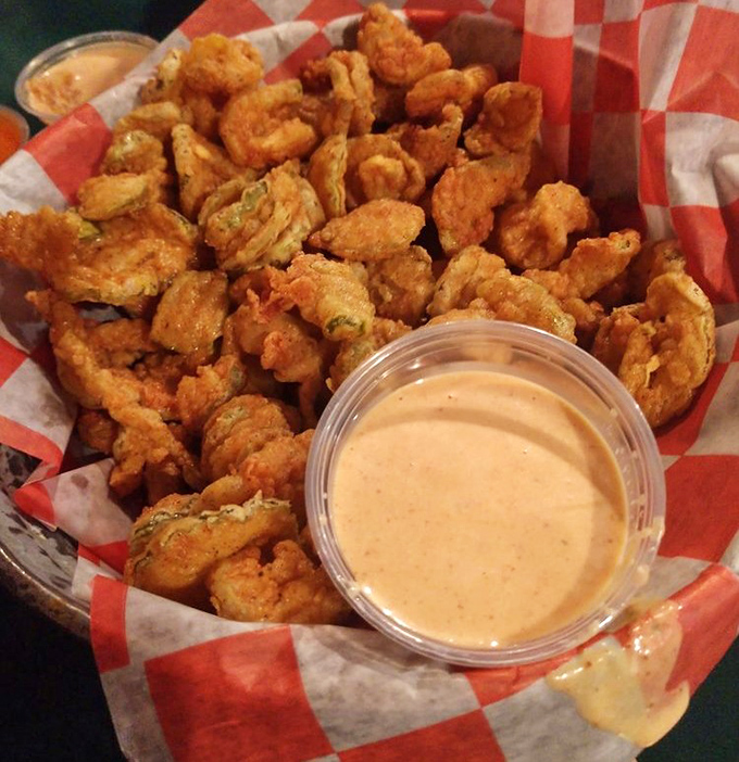 Golden-battered pickle chips that shatter with each bite. The dipping sauce isn't optional&mdash;it's the perfect tangy companion to this crispy delight.