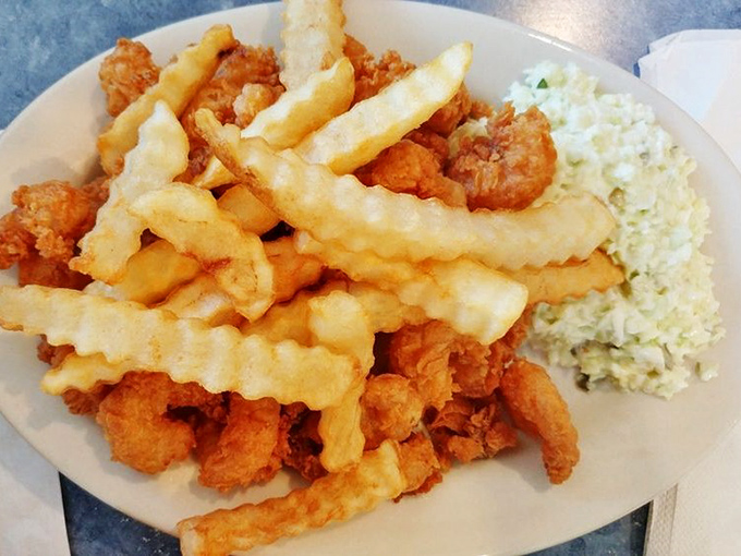 Golden-battered shrimp that snap with each bite, paired with crinkle-cut fries that would make your childhood self high-five your adult self.