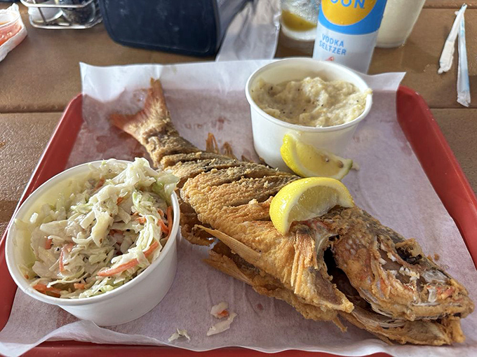 The whole fried snapper doesn't just look at you&mdash;it winks! Crispy, golden perfection with coleslaw that's actually worth eating.