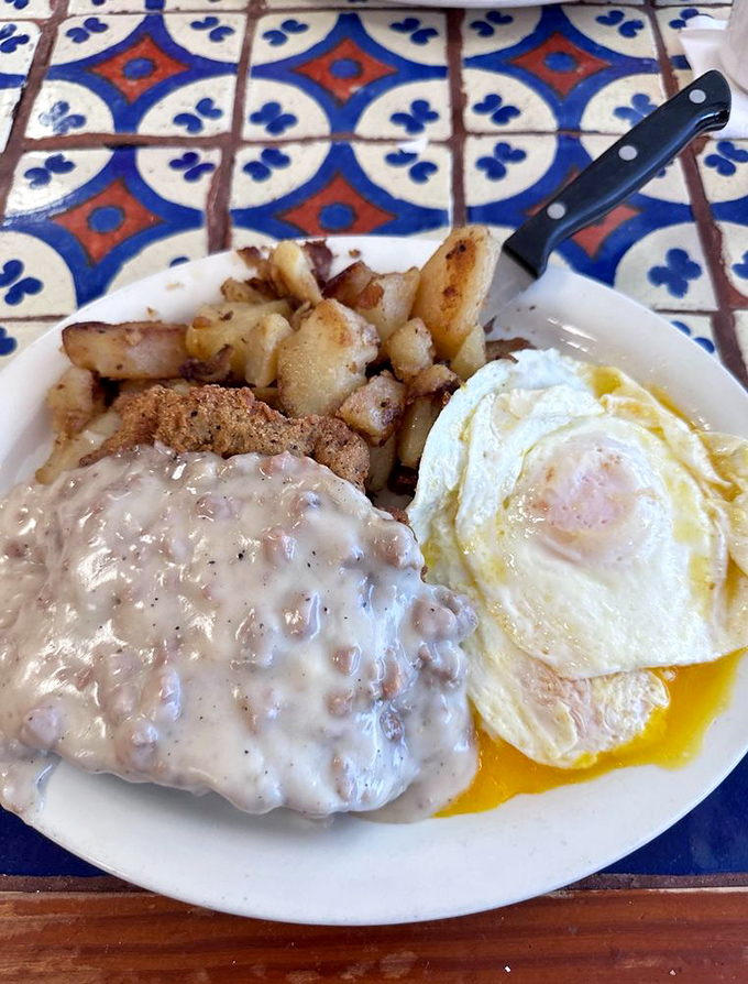 Country fried steak nirvana&mdash;crispy coating, peppery gravy, and home fries that could make a potato proud. The runny egg is just showing off at this point.