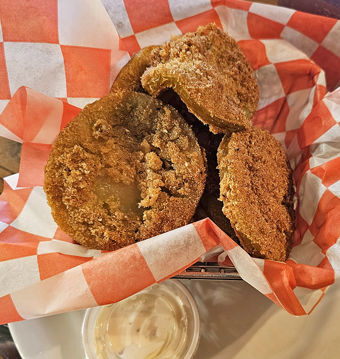 Golden-brown discs of tangy perfection nestled in a red-checkered basket. These fried green tomatoes aren't just appetizers&mdash;they're edible Southern history.
