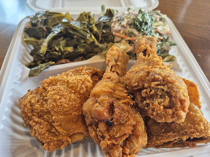 Golden-brown perfection meets Southern tradition on this plate. The collard greens and coleslaw aren't just sides&mdash;they're supporting actors deserving their own Oscar.