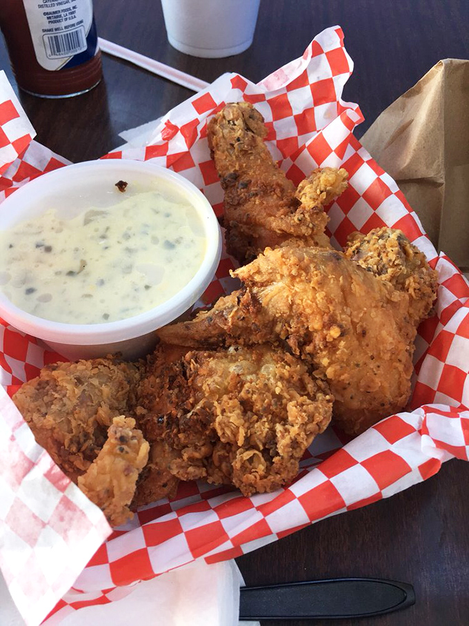 Golden-brown perfection! This fried chicken's crackling crust gives way to juicy meat beneath, served with a side of creamy dipping sauce that elevates every bite.