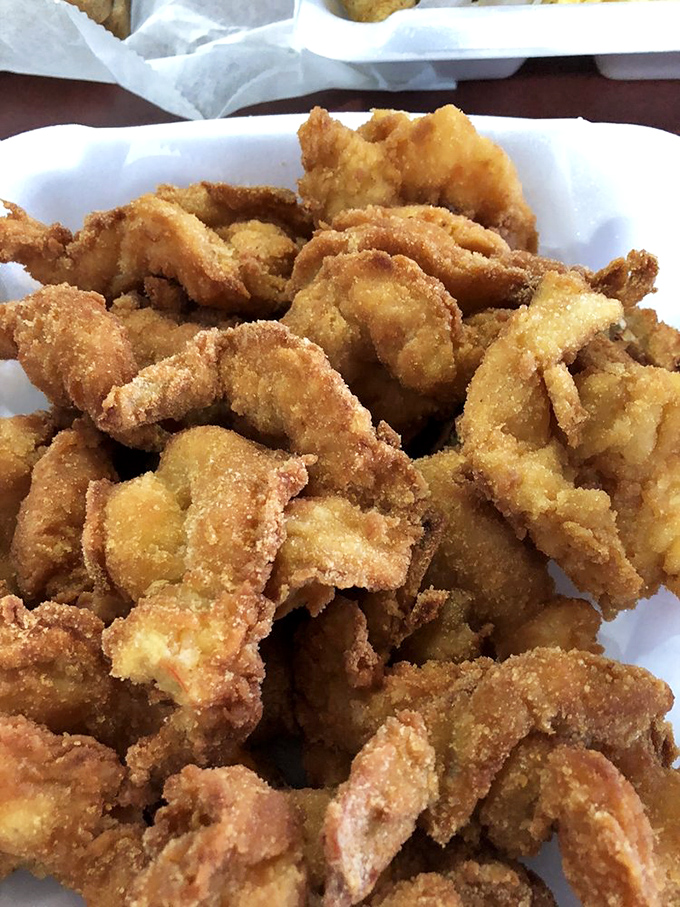 Golden-fried perfection that makes you question every other shrimp you've ever eaten. These crispy crustaceans aren't just food—they're a religious experience with cocktail sauce.