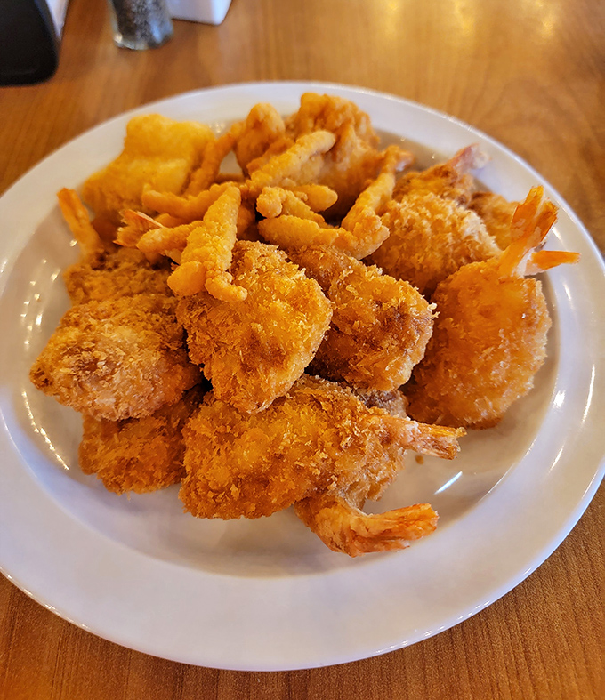 Golden-battered shrimp piled high like delicious treasure &ndash; this plate is why elastic-waist pants were invented for buffet expeditions.