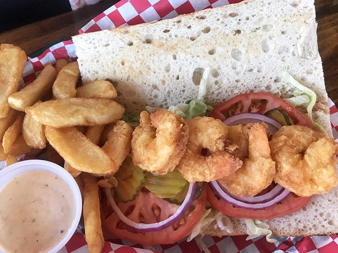 This isn't just a shrimp po-boy; it's a masterclass in sandwich architecture. Crispy golden shrimp nestled in fresh veggies&mdash;a beautiful relationship on bread.