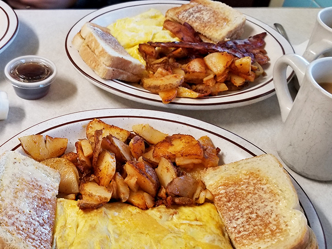 Breakfast nirvana: golden-crisp home fries nestled against perfectly toasted bread and fluffy eggs. This plate doesn't need Instagram filters—it's already wearing its Sunday best.