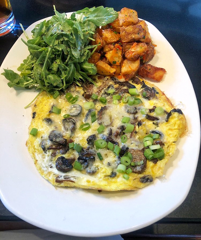 The star of the show: a mushroom frittata that makes ordinary eggs question their life choices. Those breakfast potatoes deserve their own fan club.