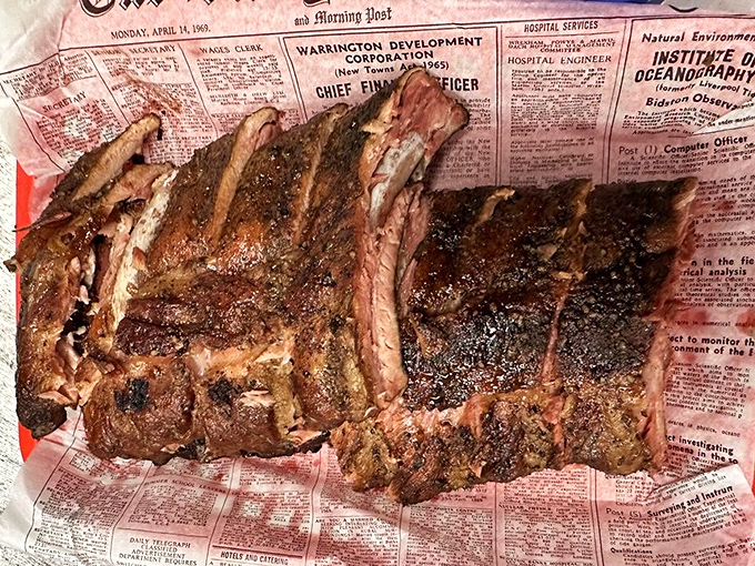 Behold the bark on these ribs! Newspaper-wrapped perfection that makes you want to cancel your afternoon plans.