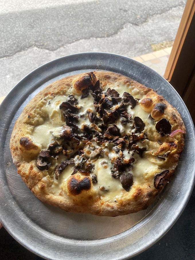 This funghi pizza isn't just food; it's a revelation of earthy mushrooms dancing atop perfectly charred crust. Pizza nirvana exists, and it's right here.