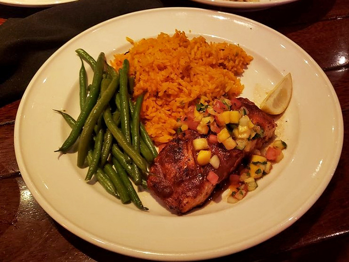 Not just salmon, but a revelation on a plate&mdash;perfectly glazed, nestled beside vibrant green beans and orange rice that tastes like sunshine decided to become a side dish.