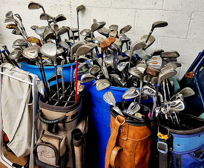 Golf club jungle! Somewhere in this metallic forest is the putter that will finally improve your game—or at least your garage decor.