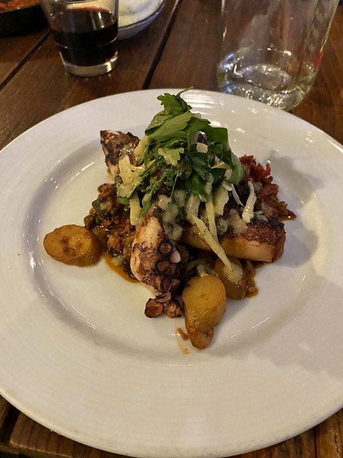 This grilled octopus isn't just cooked, it's transformed&mdash;tender tentacles nestled among potatoes with a garden-fresh slaw that'll convert any skeptic.