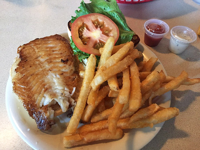 This grouper sandwich isn't just lunch—it's Florida on a plate. Perfectly grilled fish, fresh toppings, and those golden fries demand a moment of silence.