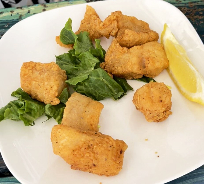 Golden-fried grouper nuggets that make you question every fish stick you've ever eaten. That lemon wedge isn't decoration &ndash; it's the perfect dance partner.