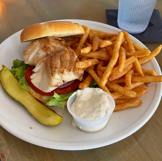 This blackened grouper sandwich isn't just lunch&mdash;it's a Florida rite of passage, served with a pickle spear standing at attention like it knows it's in the presence of greatness.