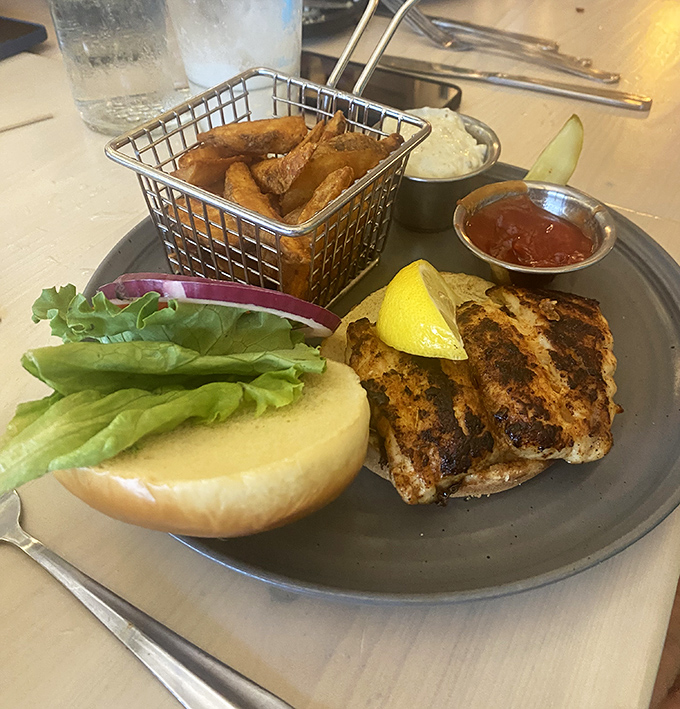 The star of the show: blackened grouper with golden fries. This sandwich doesn't need Instagram filters—it's naturally photogenic.