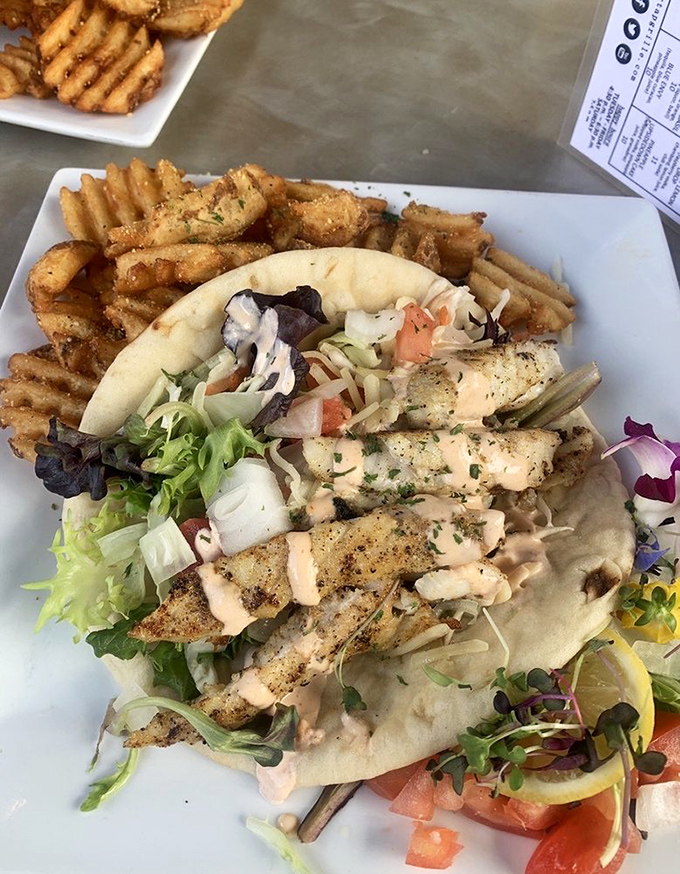 Behold the headliner: grouper tacos with crispy waffle fries. That perfect flake, the fresh toppings, the hint of sriracha lime crema&mdash;this is why people drive across state lines for lunch.