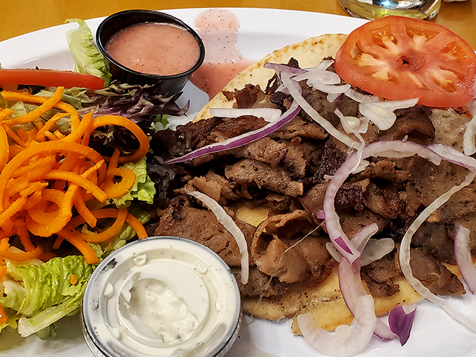 This isn't just a gyro; it's a masterclass in balance – perfectly seasoned meat, fresh veggies, and tzatziki sauce that dreams are made of.