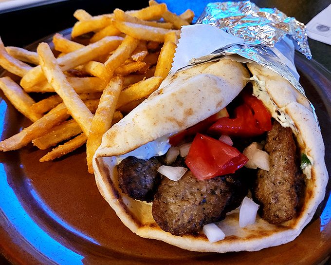 This gyro isn't just a sandwich&mdash;it's a masterpiece of seasoned meat, fresh veggies, and tzatziki sauce that demands a two-handed commitment.