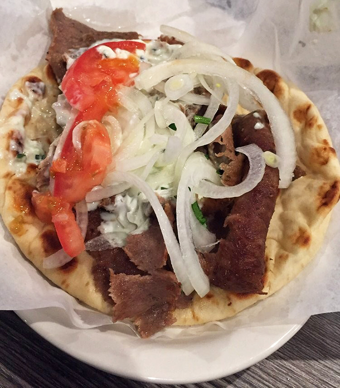 Behold the gyro in all its glory &ndash; tender meat, fresh vegetables, and tzatziki creating pure handheld happiness.