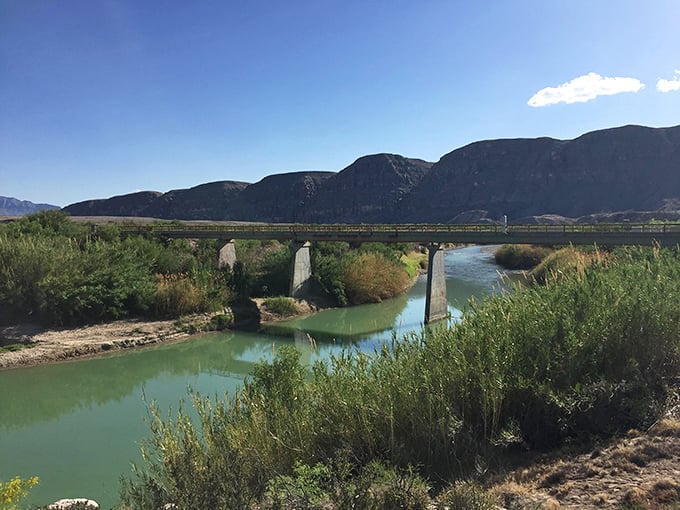 Where water meets wilderness: The bridge crossing offers a moment of reflection in a landscape that whispers stories of geological drama. 