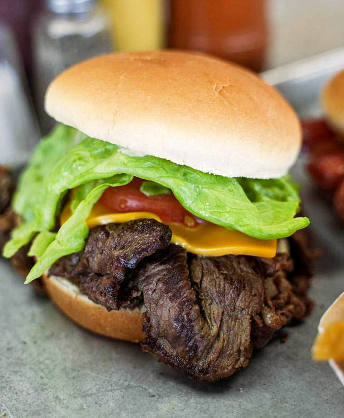 Not just any steak sandwich&mdash;this is what happens when meat decides to have its best day ever. The cheese melts with purpose, the lettuce provides the necessary crunch rebellion.