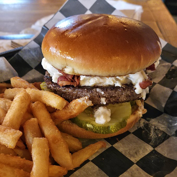 Behold, burger perfection: a golden-brown bun cradling a juicy patty topped with what appears to be bacon and cheese&mdash;proof that sometimes the simplest pleasures are the most profound. 