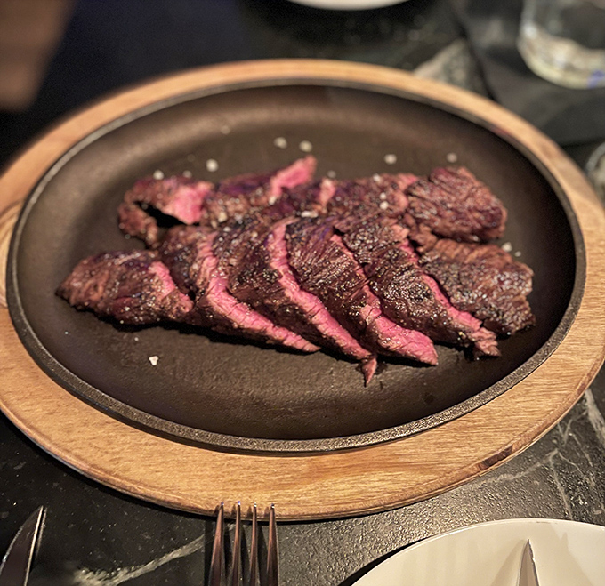 Perfectly seared hanger steak, sliced to showcase that glorious medium-rare interior. Meat this good doesn't need fancy tricks&mdash;just respect and proper technique.