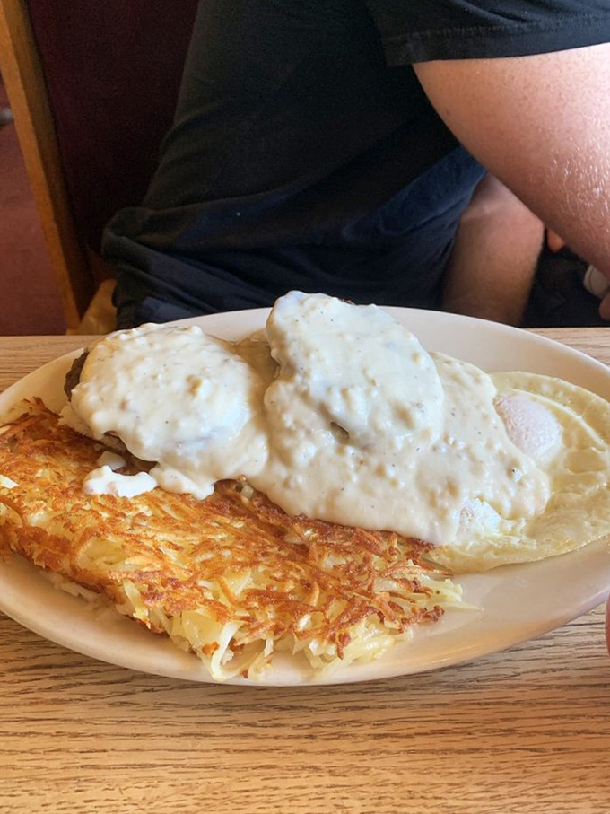 Golden hashbrowns that crackle with each bite, smothered in country gravy. Breakfast architecture at its most deliciously precarious.