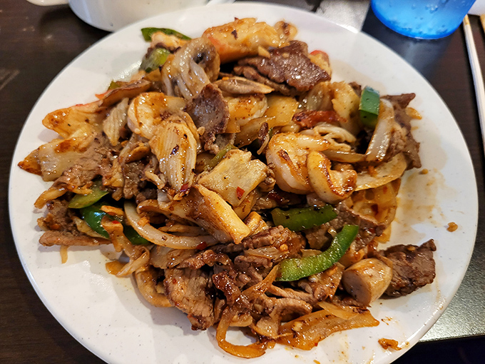 Hibachi heaven on a plate! This stir-fry masterpiece features beef, chicken, and vegetables in perfect harmony—like a delicious rock band where every ingredient gets a solo.