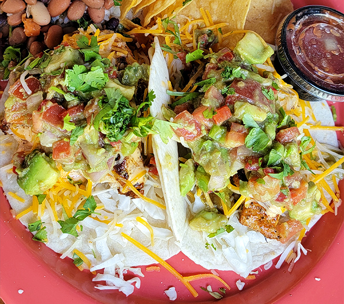 These fish tacos aren't just a meal; they're a vacation on a plate, with fresh hogfish nestled under a confetti of toppings.