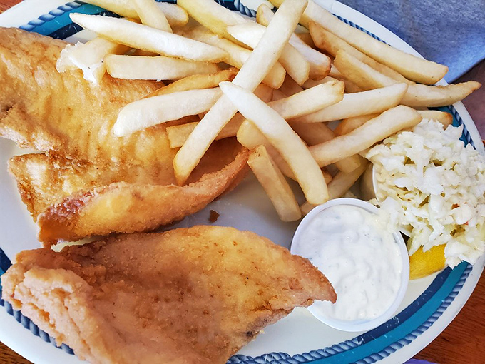 Golden-fried perfection meets French fries and coleslaw. This plate doesn't need fancy plating when the fish is this fresh.