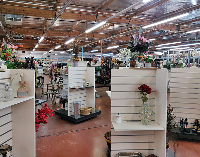 White display shelves showcase artificial flowers and decorative vases&mdash;proof that one person's "too much" becomes another's perfect accent piece.