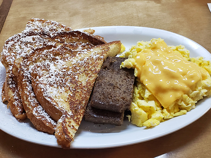 French toast dusted with powdered sugar alongside cheese-draped eggs. Breakfast nirvana exists, and it's served on this plate.