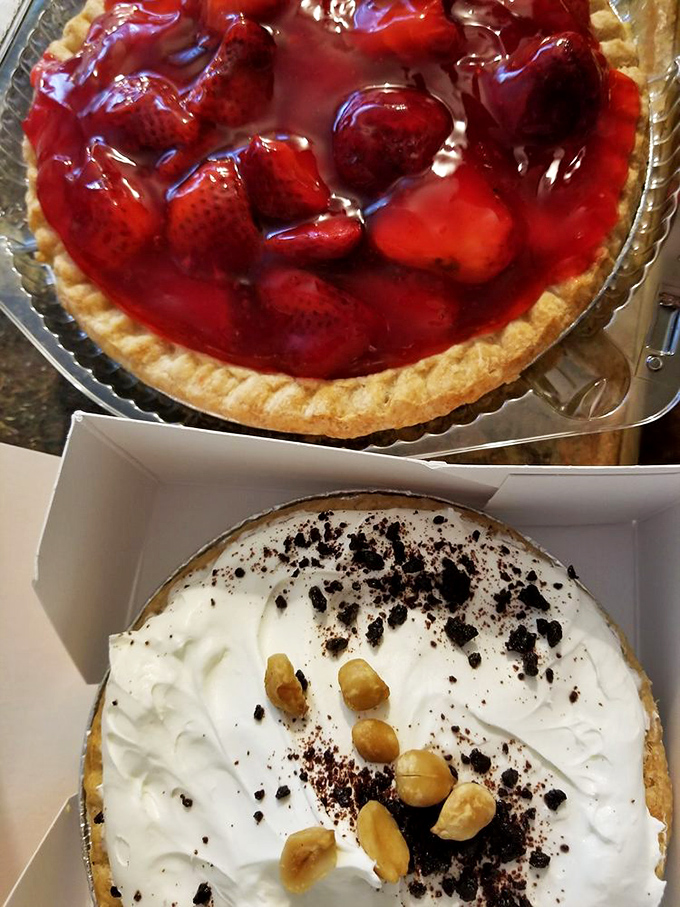 Fresh strawberries swimming in ruby glaze atop a buttery crust, while below, a cream pie stands ready for its close-up. Decisions, decisions!