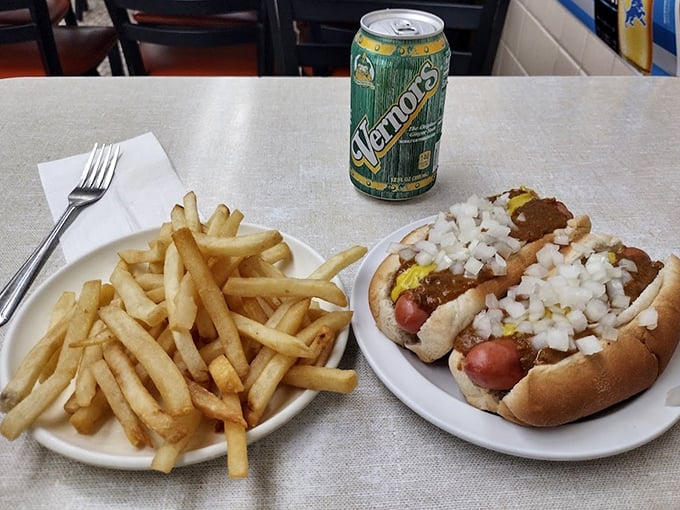 The holy trinity of Detroit dining: two perfect coney dogs, golden fries, and a Vernors. This plate is Michigan's answer to champagne and caviar.
