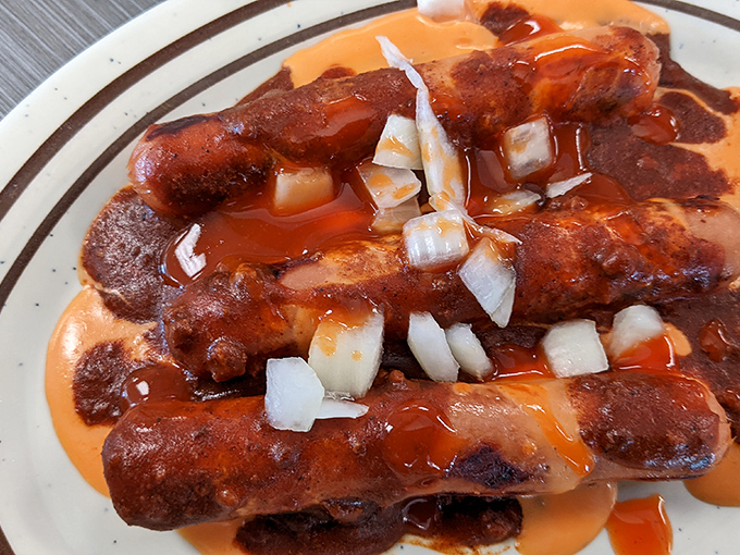 These aren't just hot dogs&mdash;they're edible works of art. The chili cascades over perfectly grilled franks while diced onions add that essential crunch.