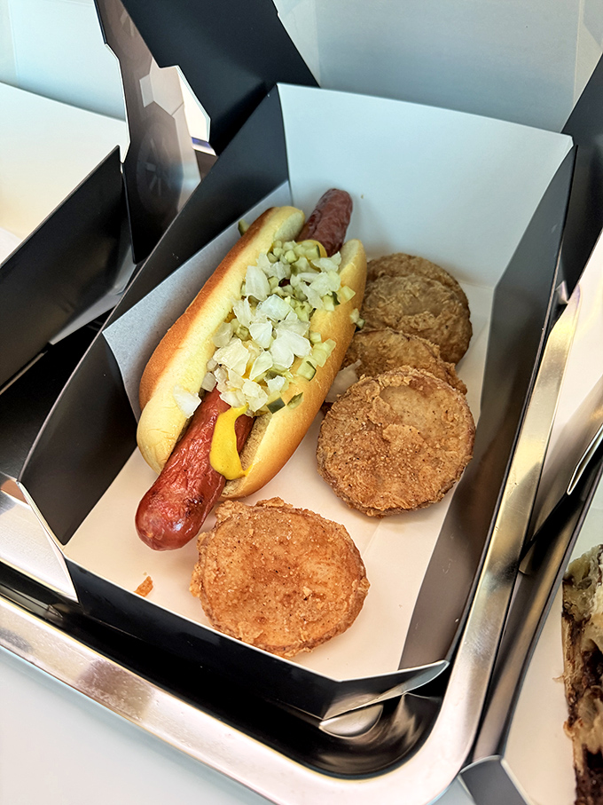 This isn't your average ballpark frank &ndash; it's a gourmet hot dog nestled in a perfect bun with crispy hash brown bites standing guard. 