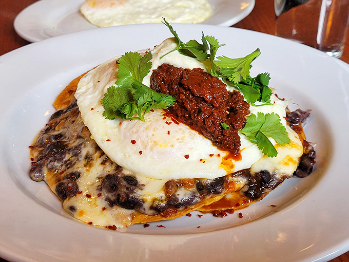Huevos rancheros reimagined with a Southern twist&mdash;where eggs meet black beans under a blanket of melted cheese and that spicy topping that makes taste buds dance.