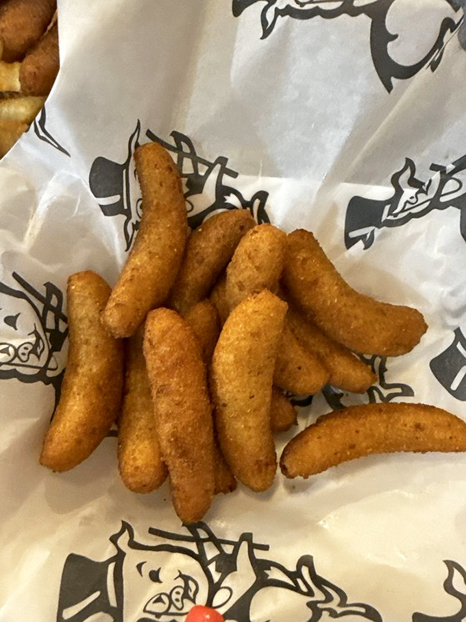 Golden-brown hush puppies that crunch like nature's perfect snack—these cornmeal miracles might be worth crossing state lines for.