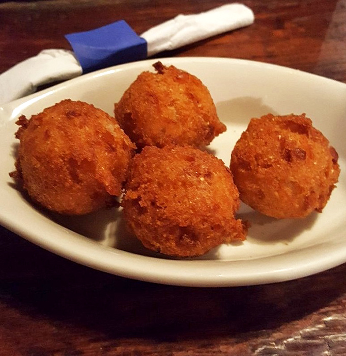 Golden orbs of cornmeal perfection that might make you forget your table manners. These hush puppies aren't just side dishes&mdash;they're the main event.