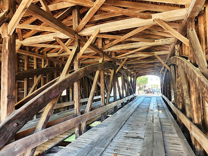 Beneath the wooden canopy, a cathedral of beams creates geometric shadows. Walking through feels like entering a time machine with splinters.