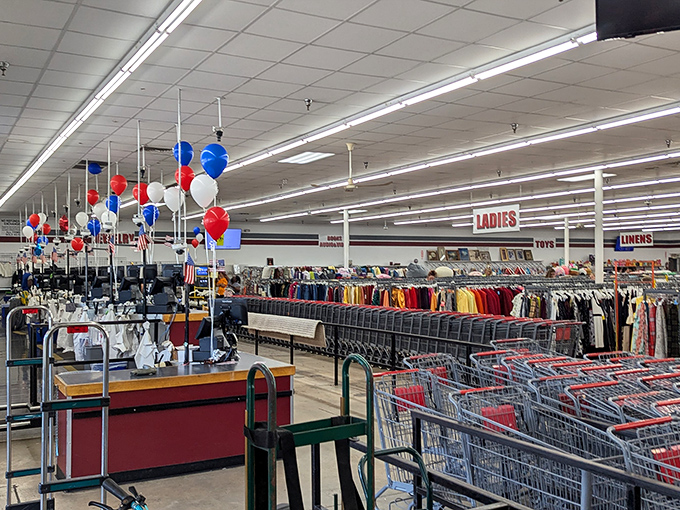 Red, white, and blue balloons dance overhead as shoppers navigate the color-coded clothing aisles&mdash;America's favorite pastime isn't baseball, it's bargain hunting.