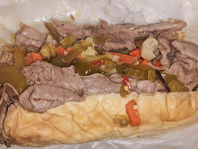 Italian beef so juicy it requires strategic eating techniques. The sweet peppers add brightness to meat that's been simmering in its own savory universe.