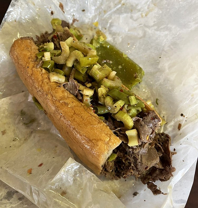 Behold the star attraction: thinly sliced beef nestled in a roll, crowned with giardiniera, and glistening with jus. Poetry in sandwich form.