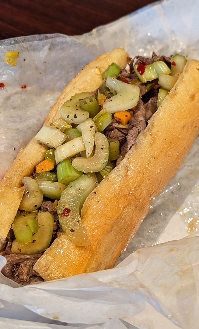 Behold the star of the show: thinly sliced beef, perfectly seasoned, nestled in that magical bread with giardiniera adding its spicy exclamation point.